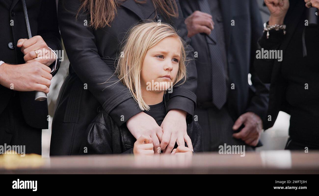 Child, sad and family at funeral at graveyard ceremony outdoor at ...