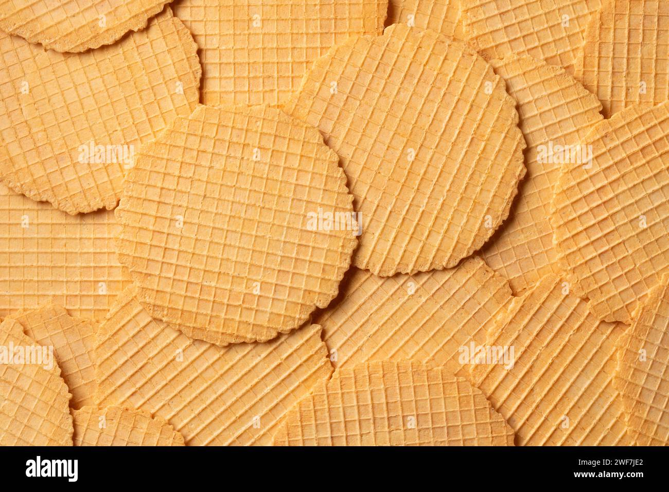 Fresh homemade baked thin cheese waffles full frame as background close ...