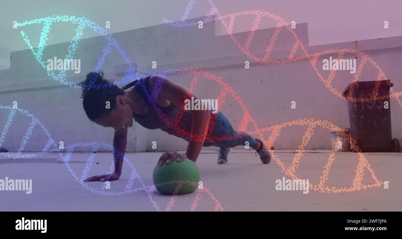 Image of dna strands spinning over woman doing press ups, exercising ...
