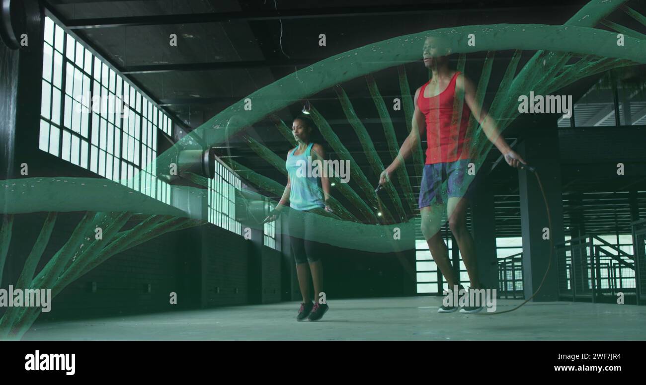 Image of dna strain spinning over man and woman woman jumping rope ...