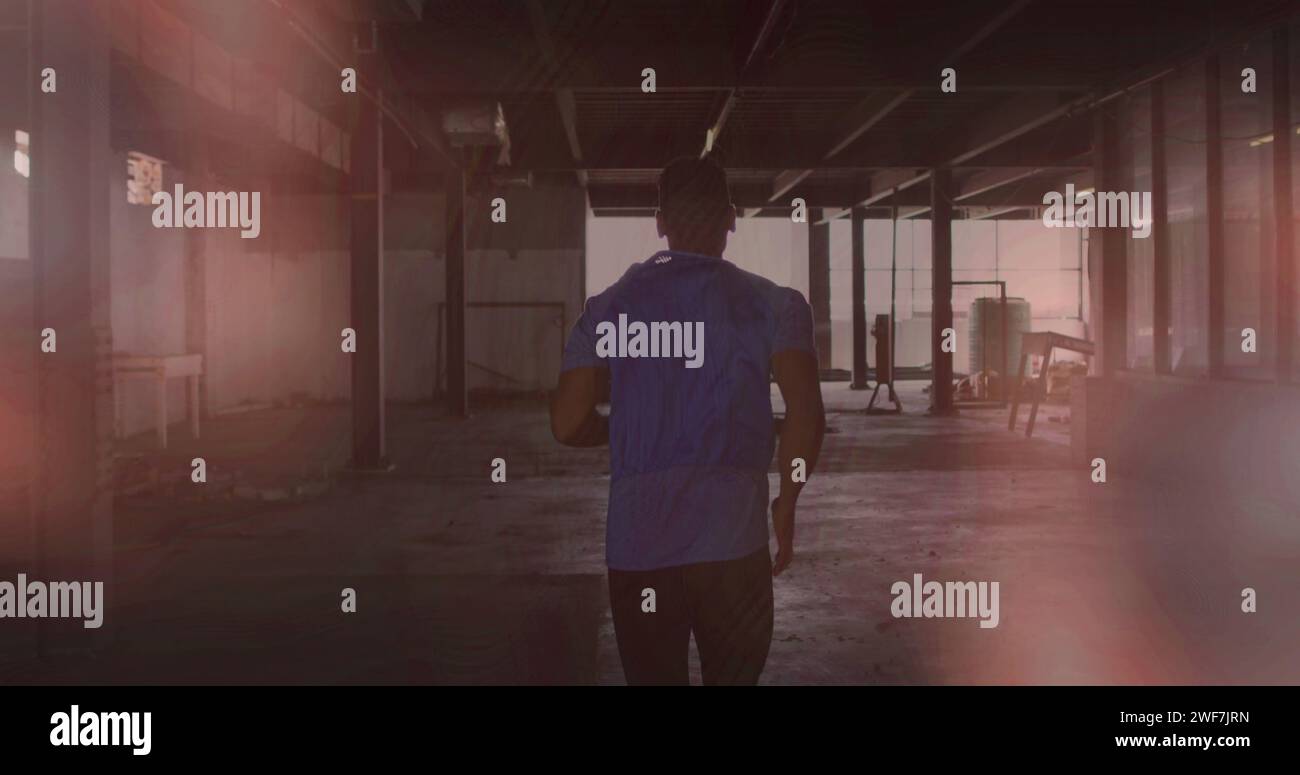 Image of colourful shapes over man jogging in an abandoned building ...