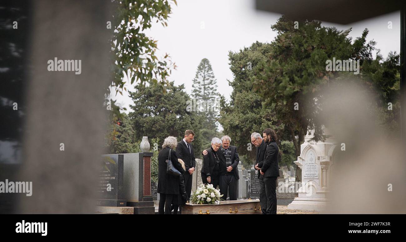 People at a funeral, death and graveyard with family mourning outdoor ...