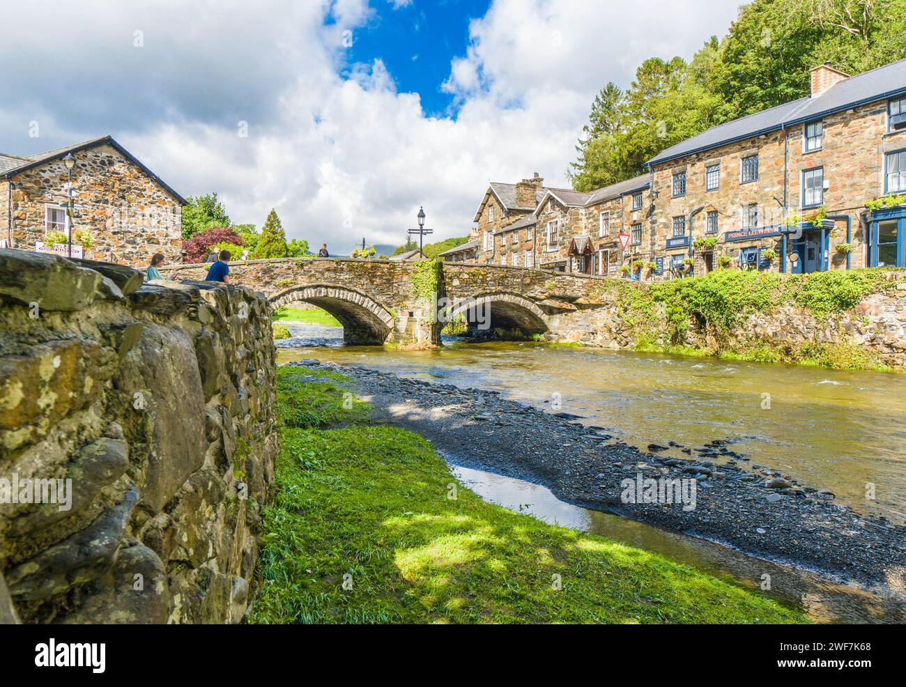 Stone bridge of two arches crossing the river Colwyn at Beddgelert ...