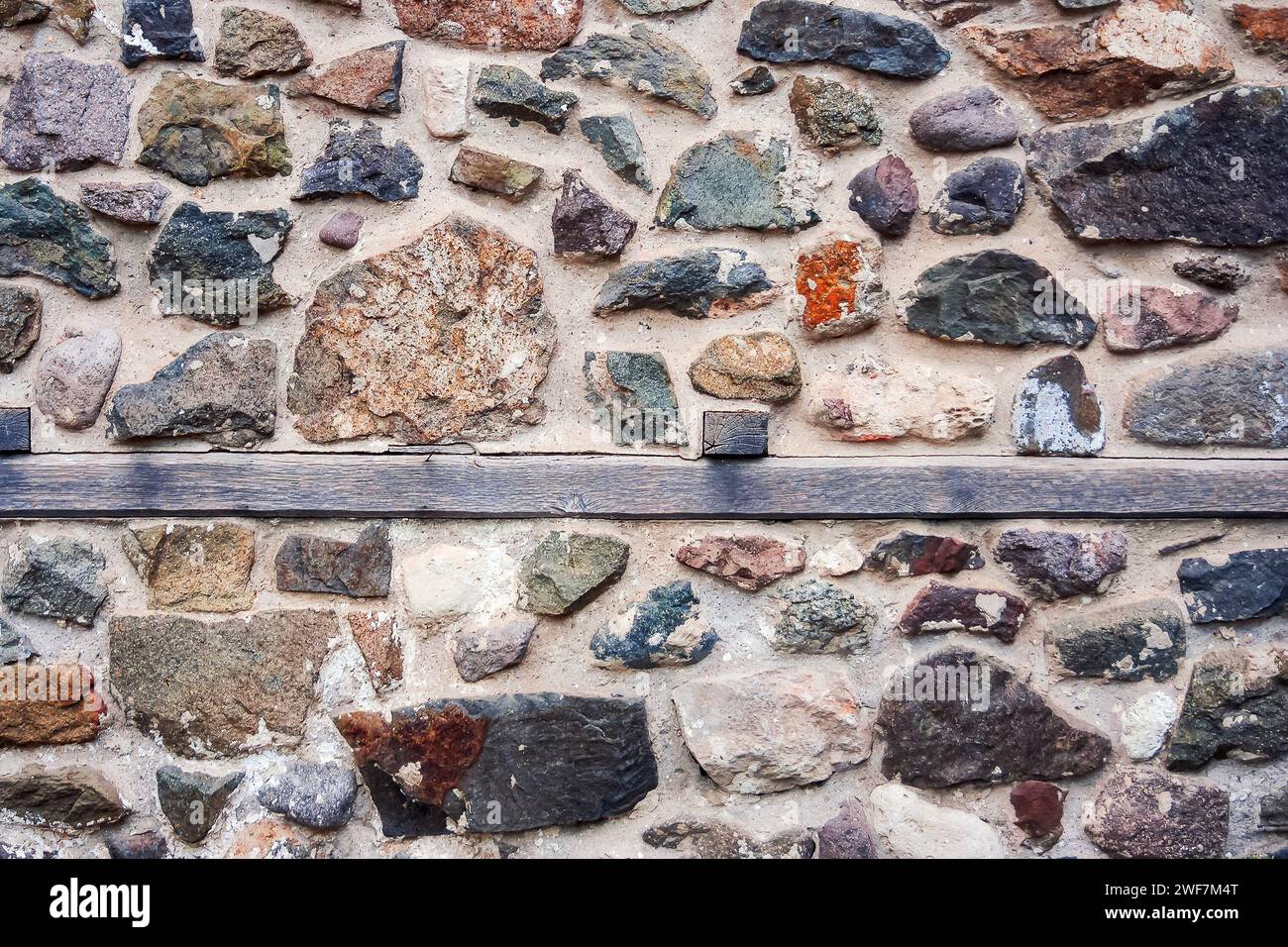 vintage stone masonry with wooden stripe in the middle. ancient ...