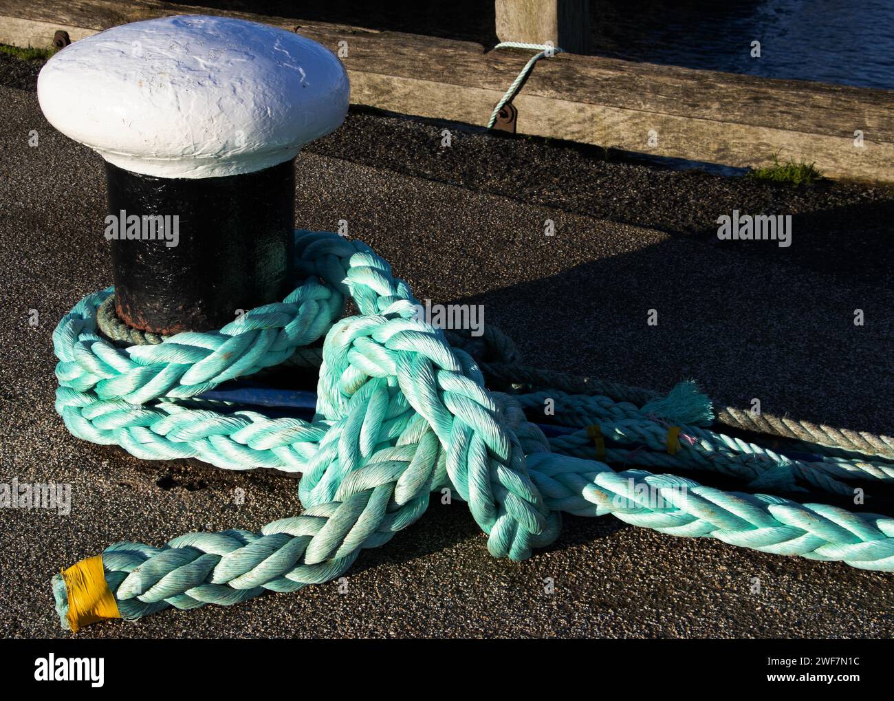 The thick plaited polypropylene rope is a securing hawser for a large ...