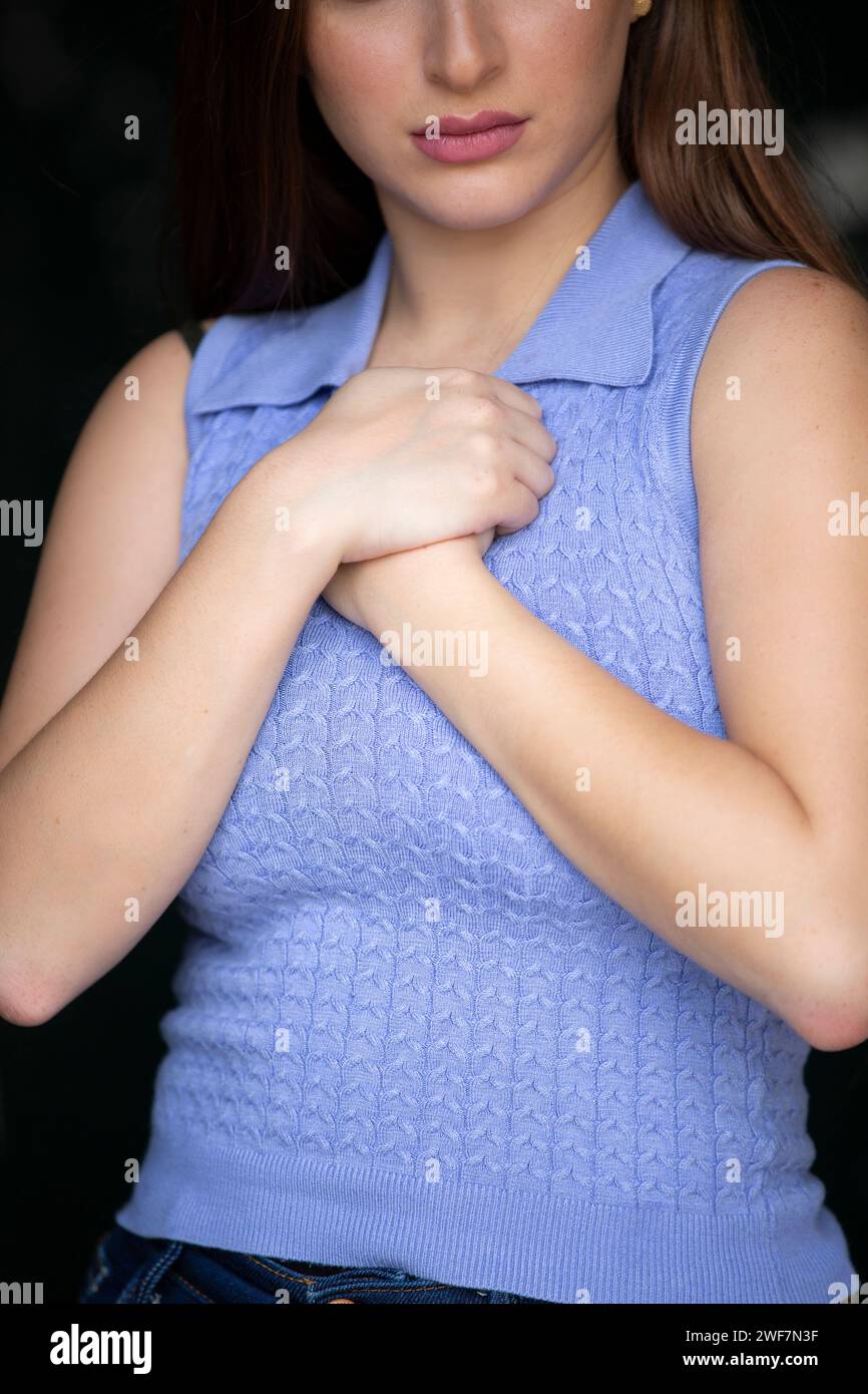 Close up of woman's hands over heart Stock Photo - Alamy