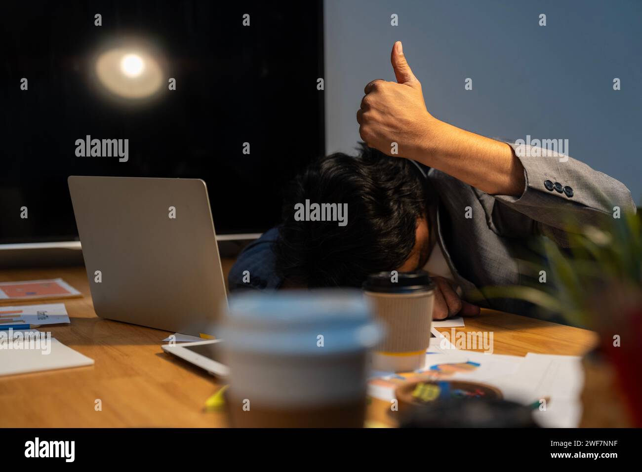 Tired employee businessman sitting work sleep laid his head down on ...