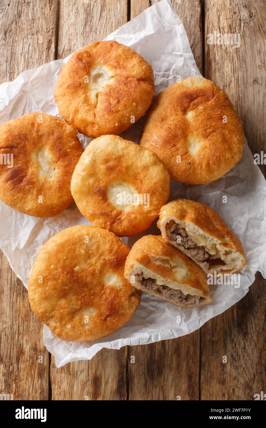 Traditional Russian deep fried meat patties belyash closeup on the ...