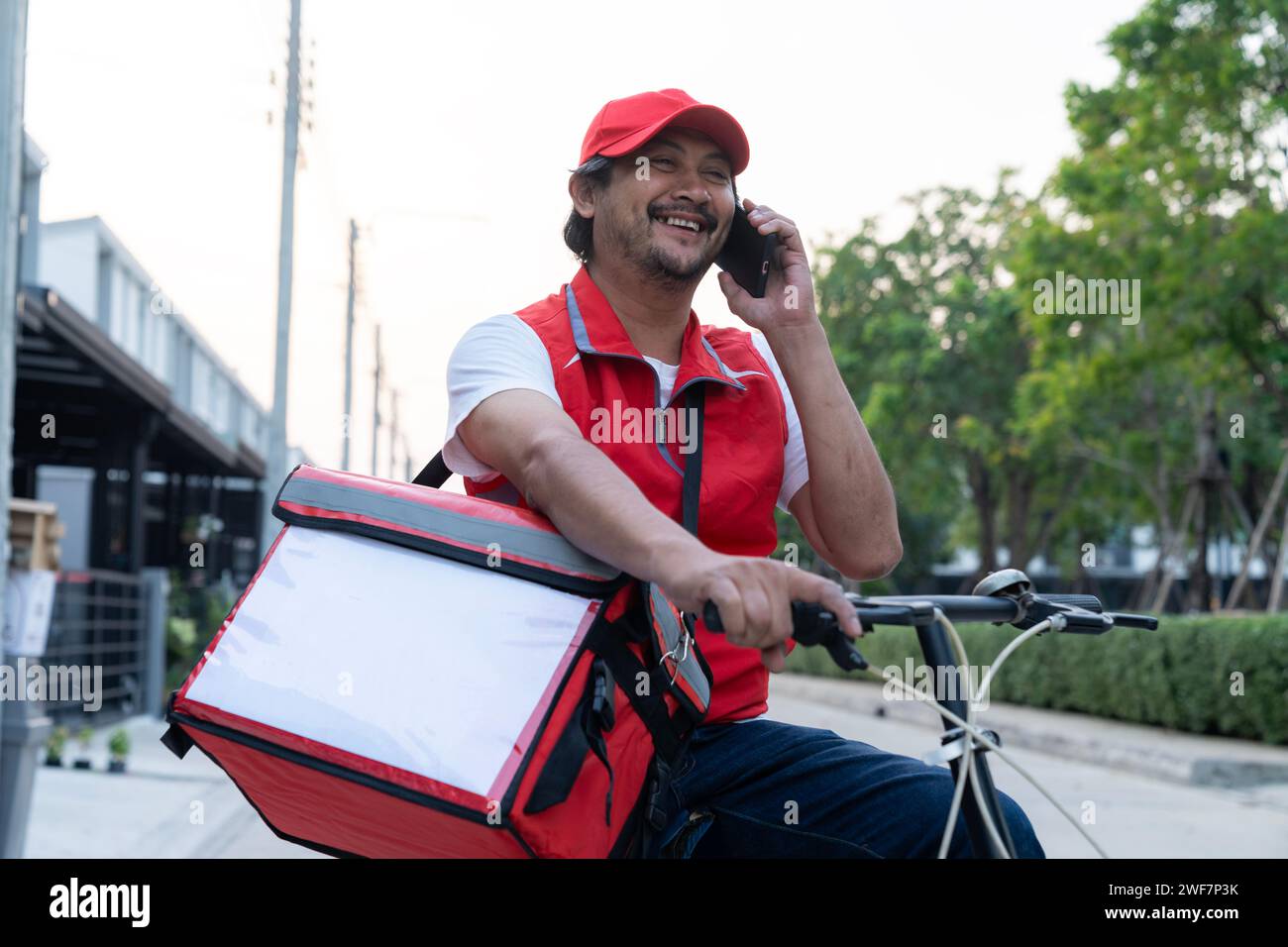 Food delivery personnel calling a customer Stock Photo - Alamy