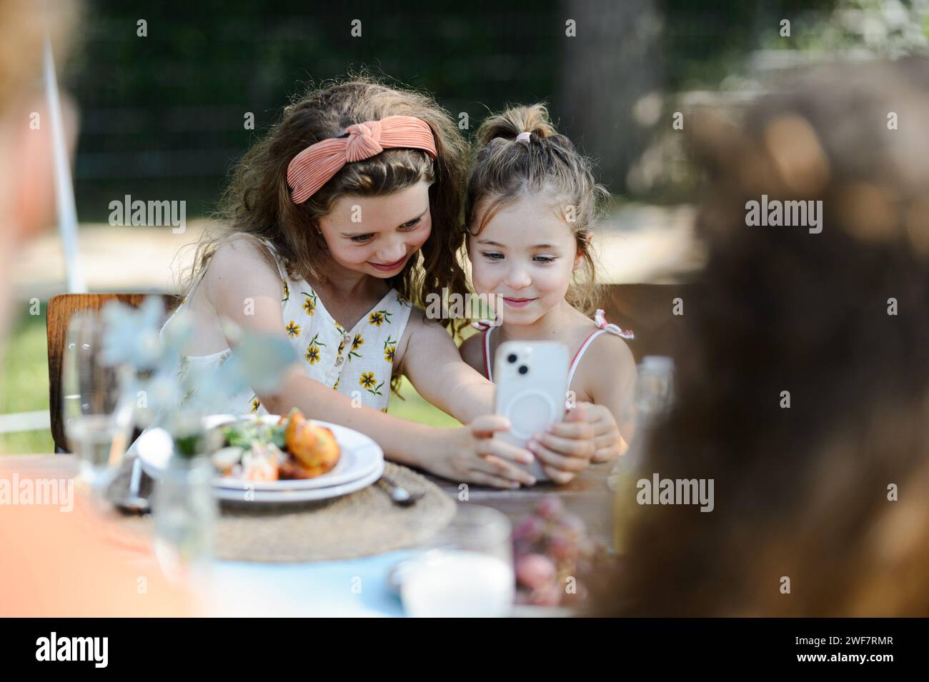 Cousins taking a selfie at a family garden party. Family reunion at ...