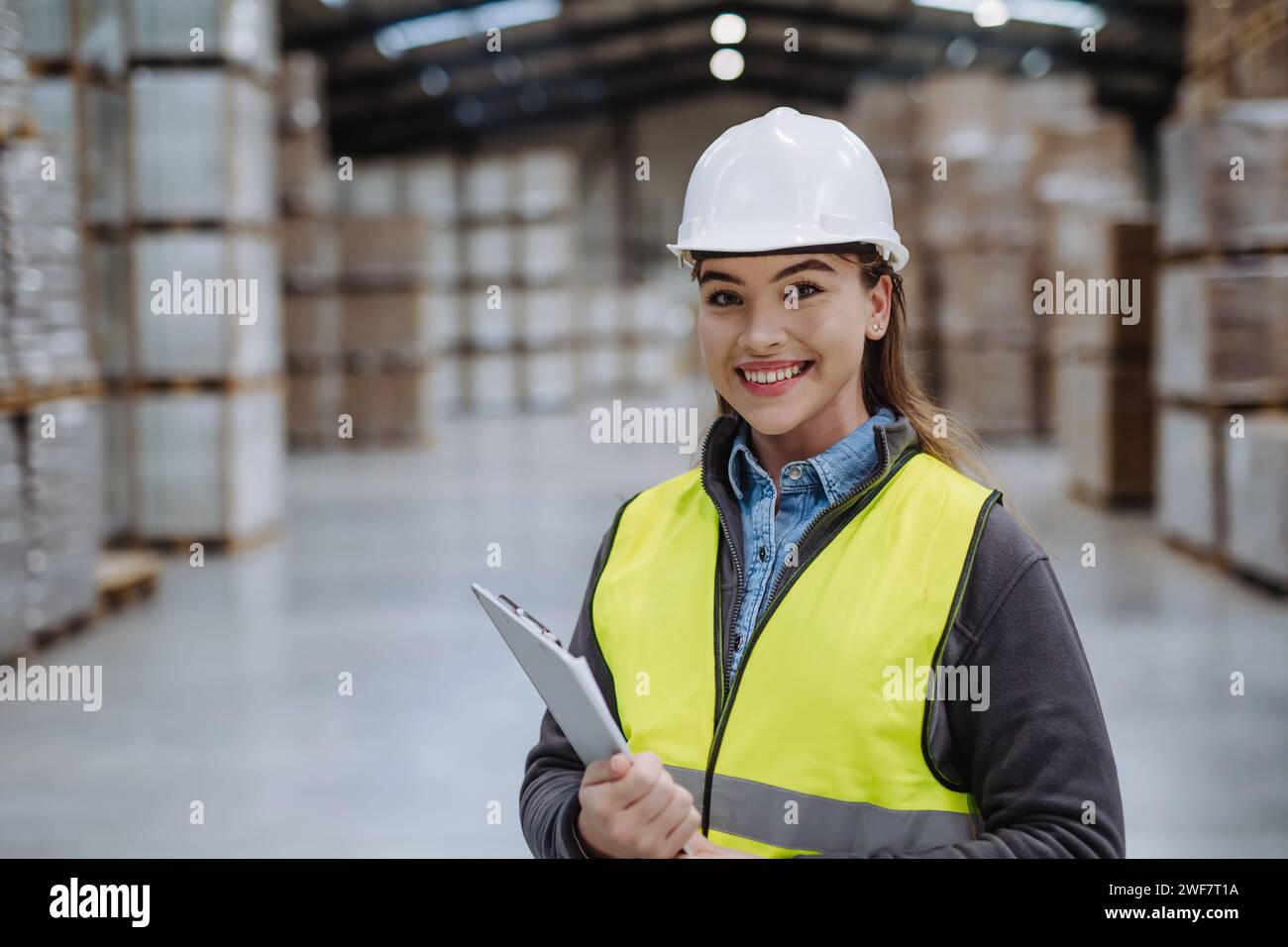 Female warehouse worker reading product order, order picking. Warehouse ...