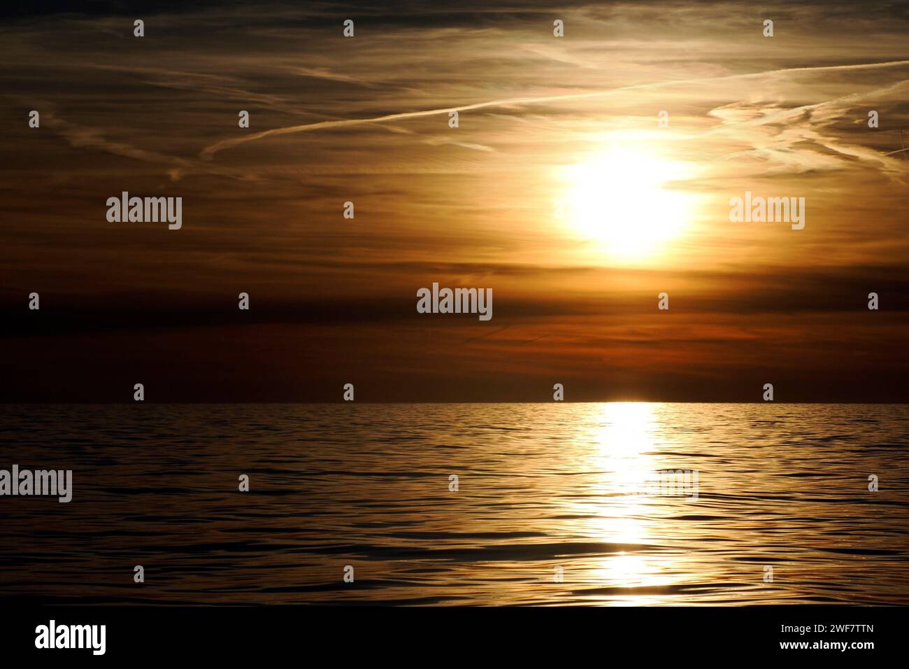 The golden sun rays reflection on the sea at sunset Stock Photo - Alamy