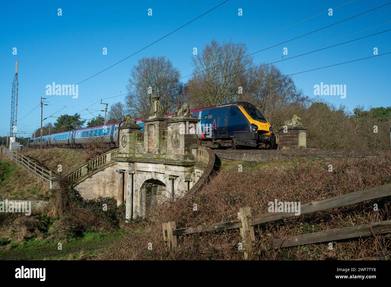COLWICH, STAFFORDSHIRE, ENGLAND. JANUARY 2024. Avanti train travelling over an ornate railway ...