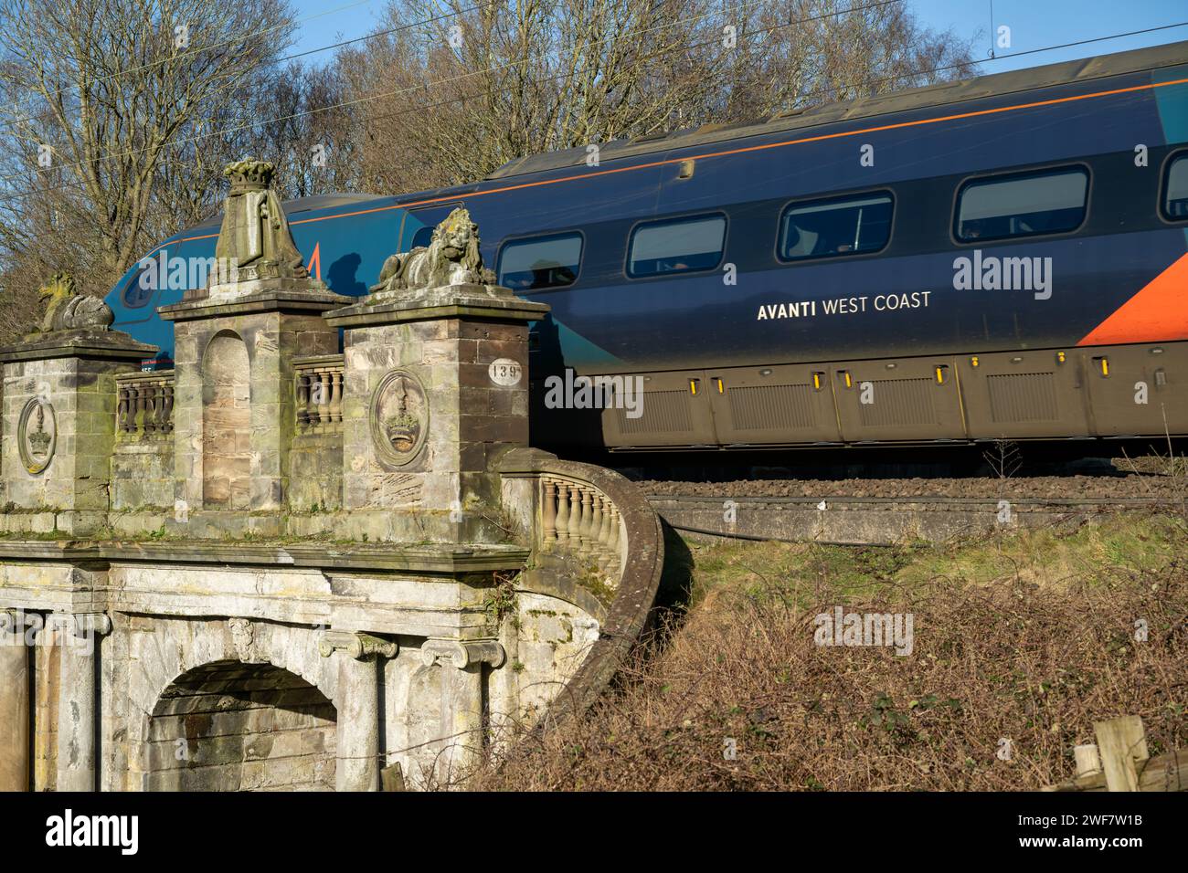 COLWICH, STAFFORDSHIRE, ENGLAND. JANUARY 2024. Avanti train travelling over an ornate railway ...