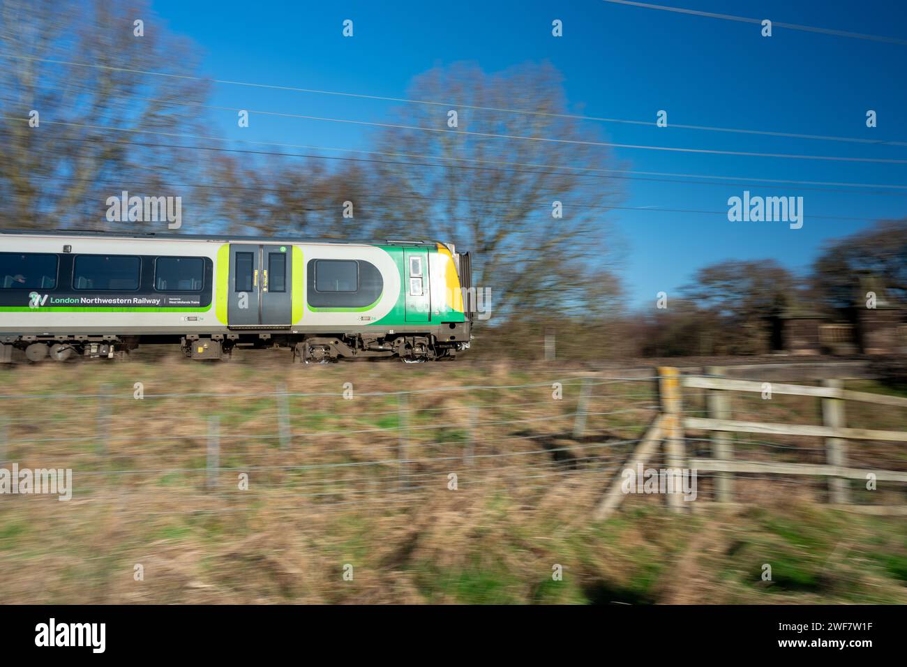 COLWICH, STAFFORDSHIRE, ENGLAND. JANUARY 2024. London Northwestern Railway train travelling over ...