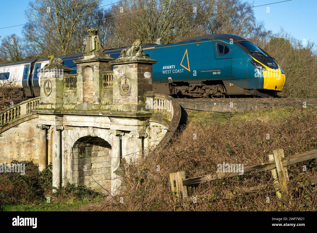 COLWICH, STAFFORDSHIRE, ENGLAND. JANUARY 2024. Avanti train travelling over an ornate railway ...