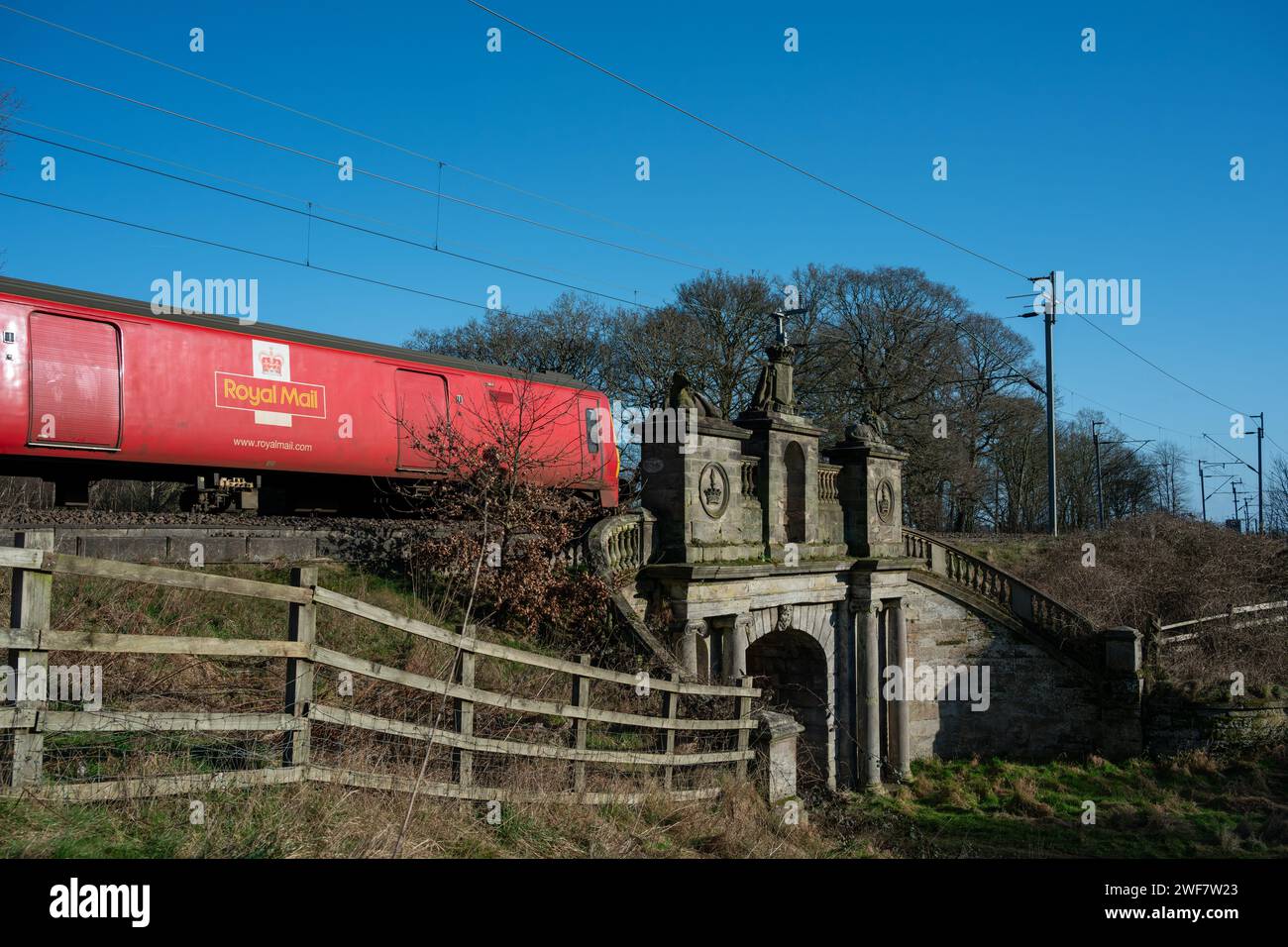 COLWICH, STAFFORDSHIRE, ENGLAND. JANUARY 2024. Royal Mail freight train travelling over an ...