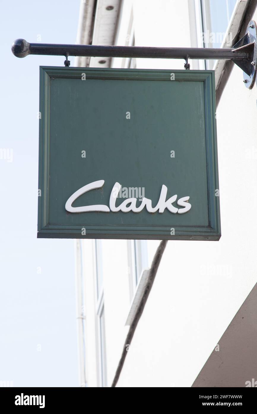 The Clarks shoe shop sign and logo hanging outside a sop in Ringwood in ...