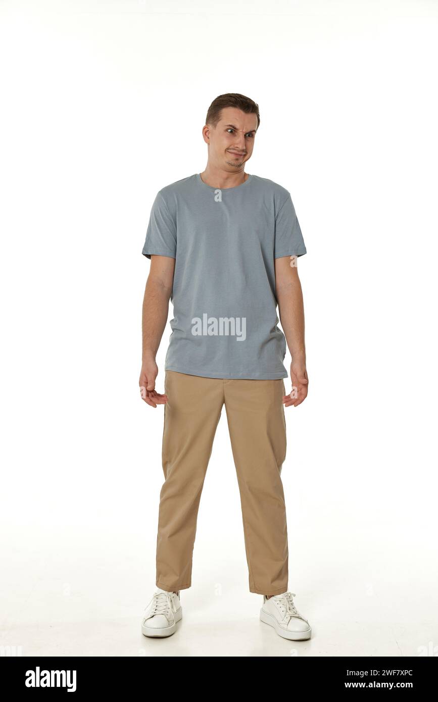 annoyed angry man standing on white studio background Stock Photo - Alamy