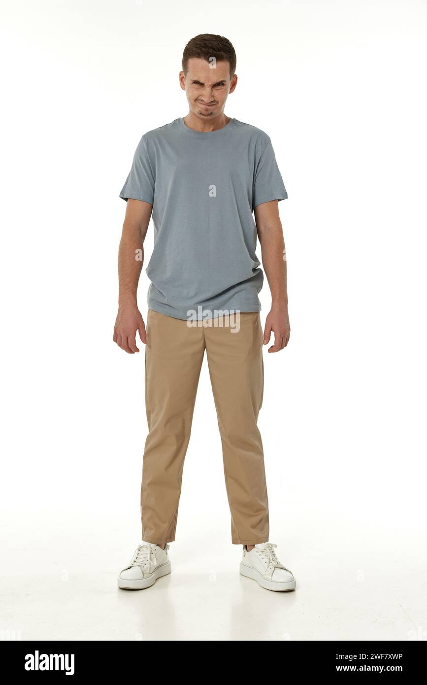 annoyed angry man standing on white studio background Stock Photo - Alamy