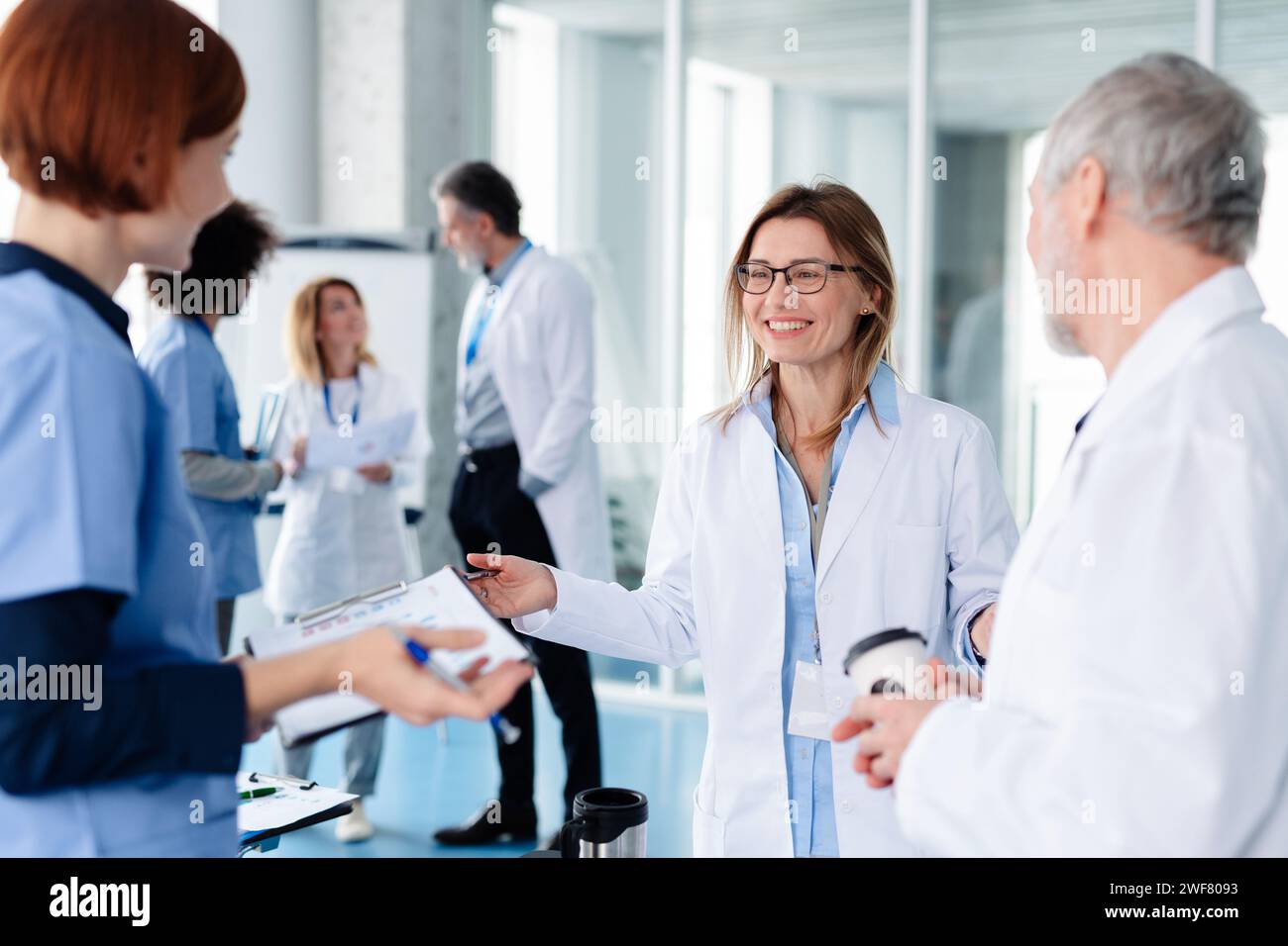Group of doctors talking during conference, discussing research ...