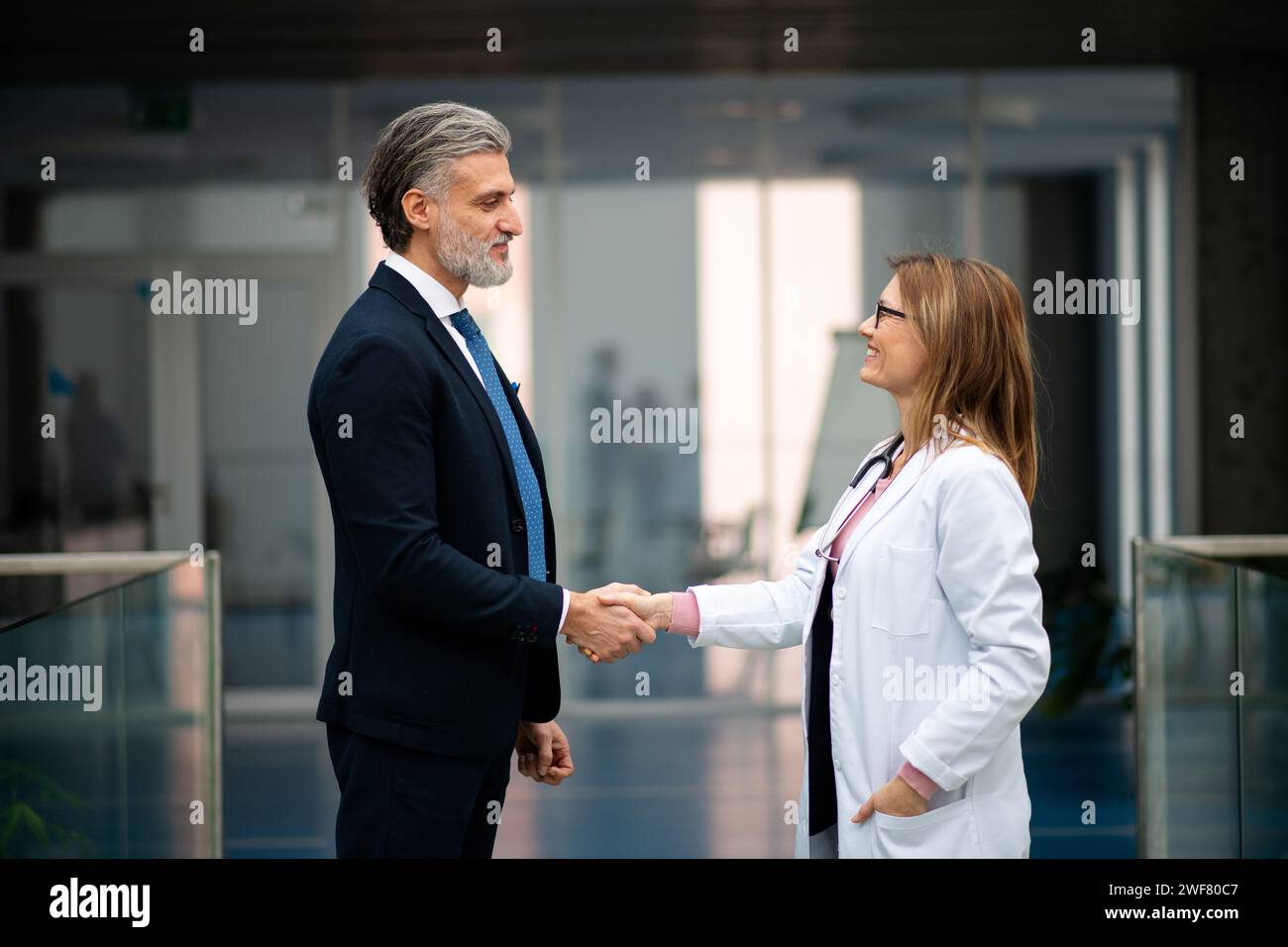Doctor talking to pharmaceutical sales representative, shaking hands ...