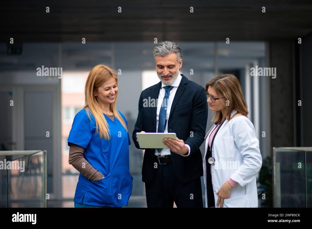 Doctors talking to pharmaceutical sales representative, presenting new ...