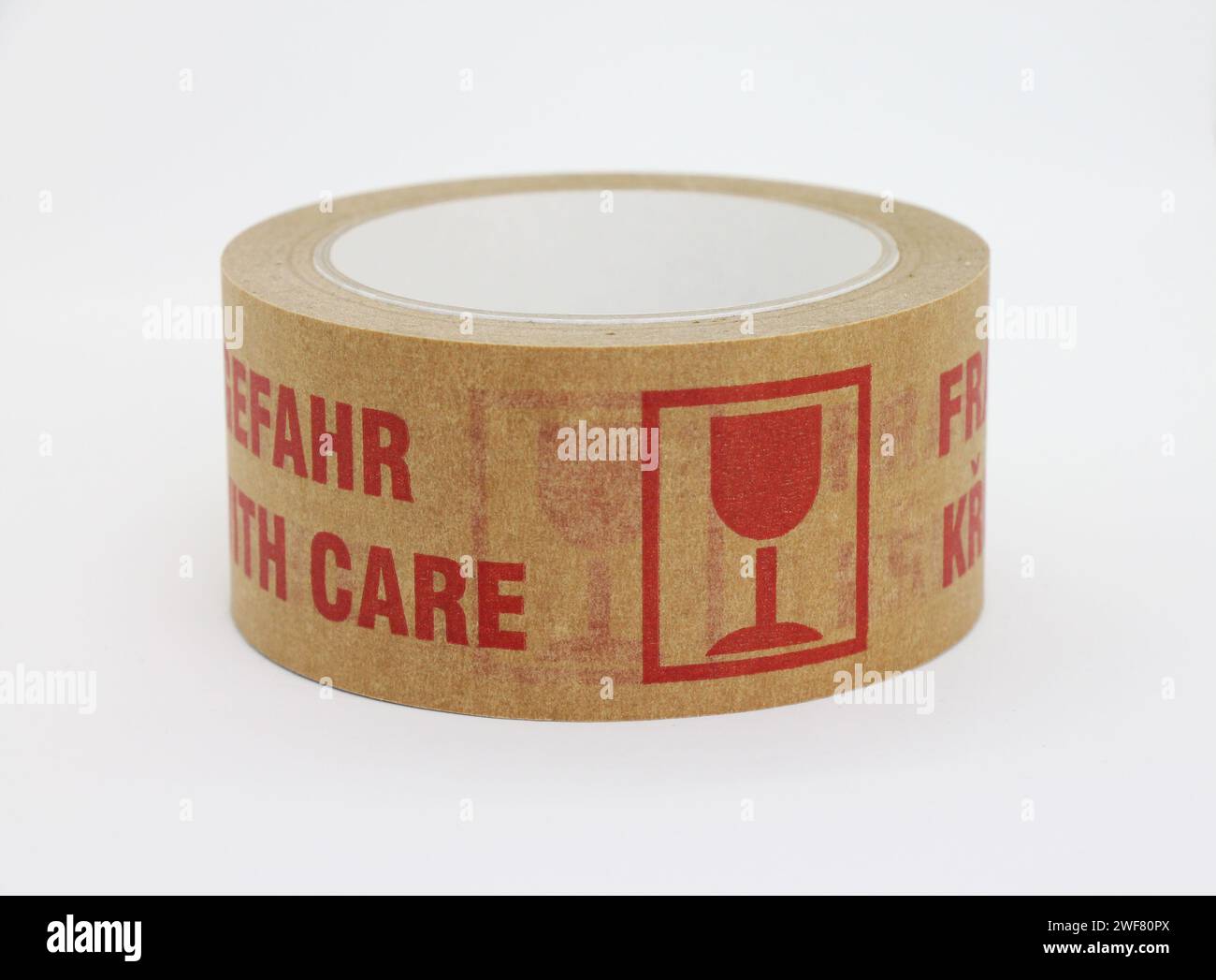 Paper adhesive tape close-up on white background. Red warning sign and ...