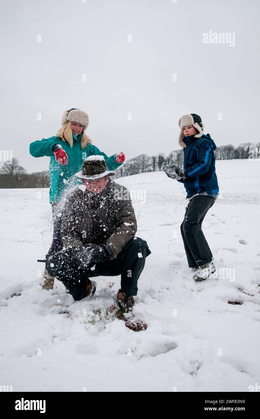 A family play snowball fights in a snowy winter landscape Stock Photo ...