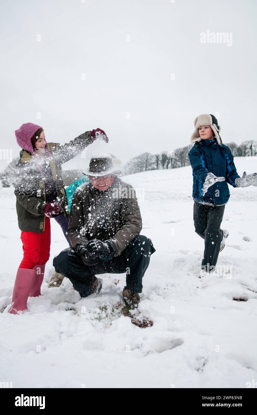 A family play snowball fights in a snowy winter landscape Stock Photo ...
