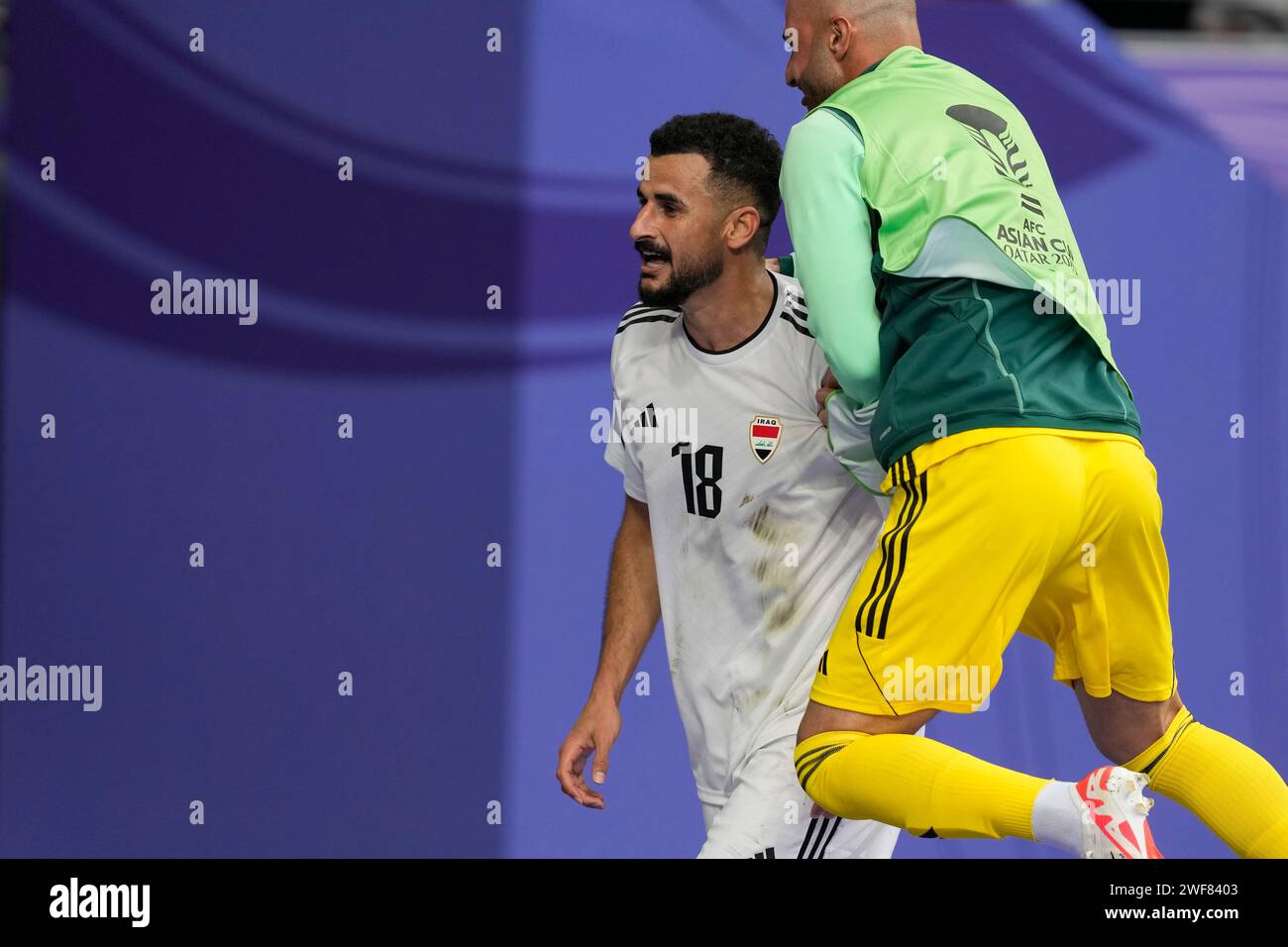 Iraq's Aymen Hussein, centre, celebrates after scoring his side's ...