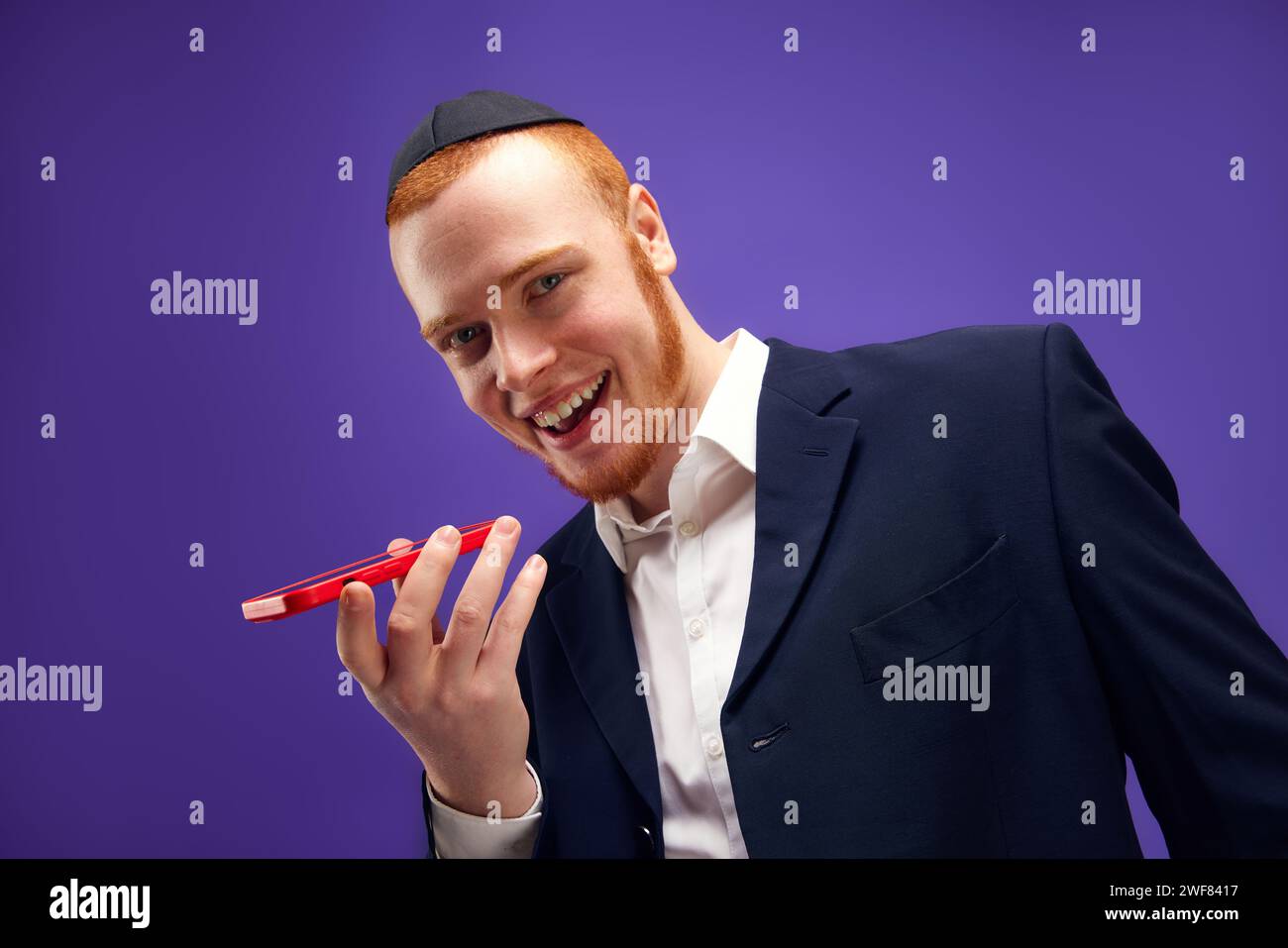Young Jewish smiling man recording voice message, greeting with holiday ...
