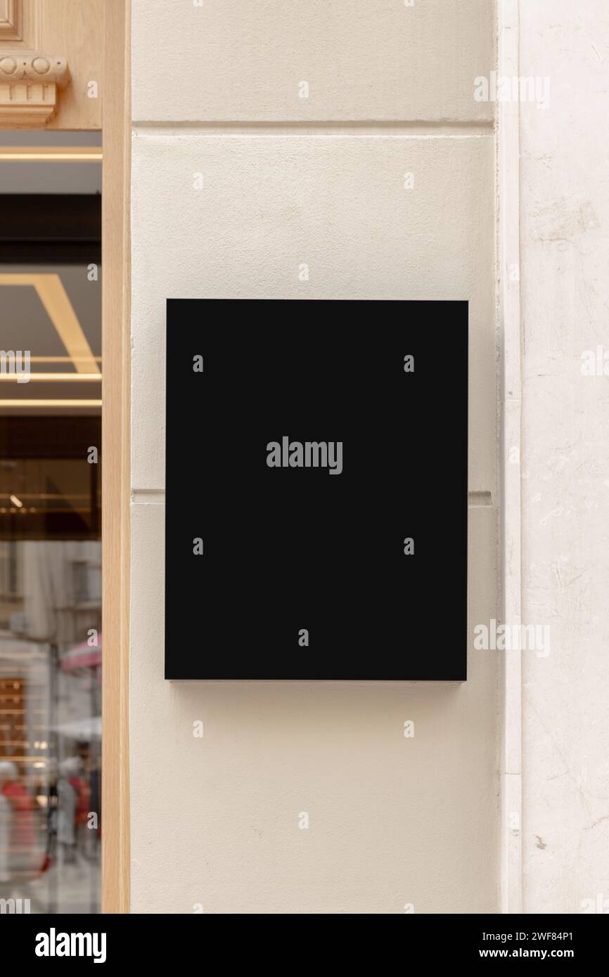Wall-mounted black signboard on a textured wall, ideal for businesses ...