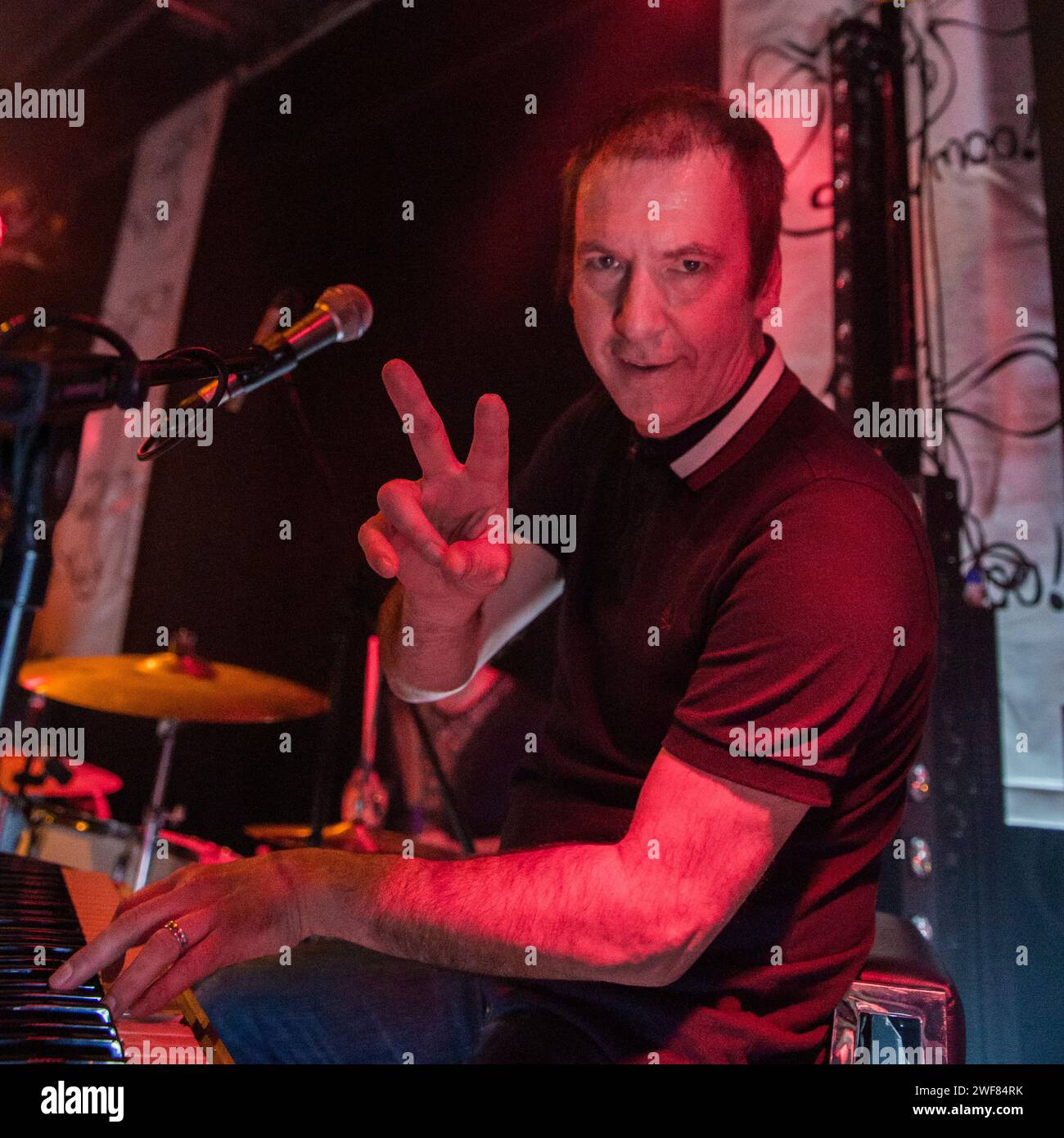 Clint Boon on keyboards, giving the peace sign to the camera at the ...