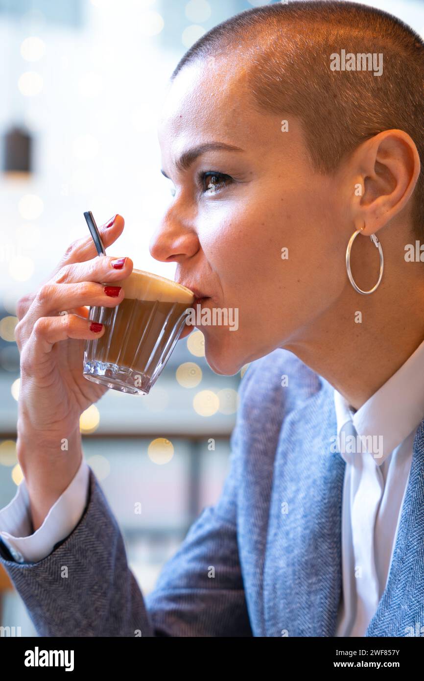 Vertical portrait side view stylish woman drinking coffee in cafe Stock ...
