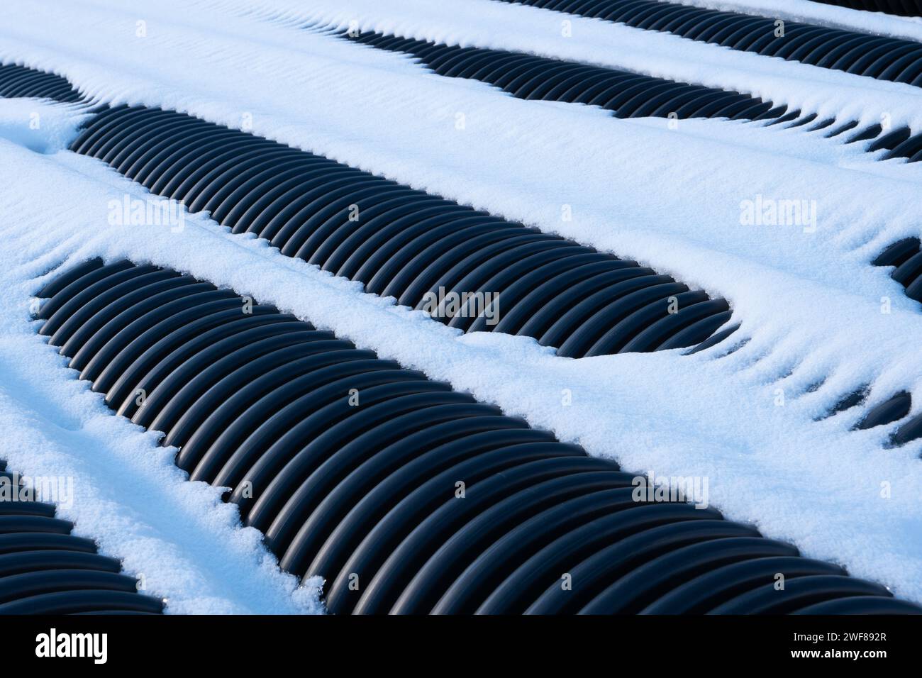 Black plastic Corrugated Drain Pipes covered by the Snow Stock Photo ...