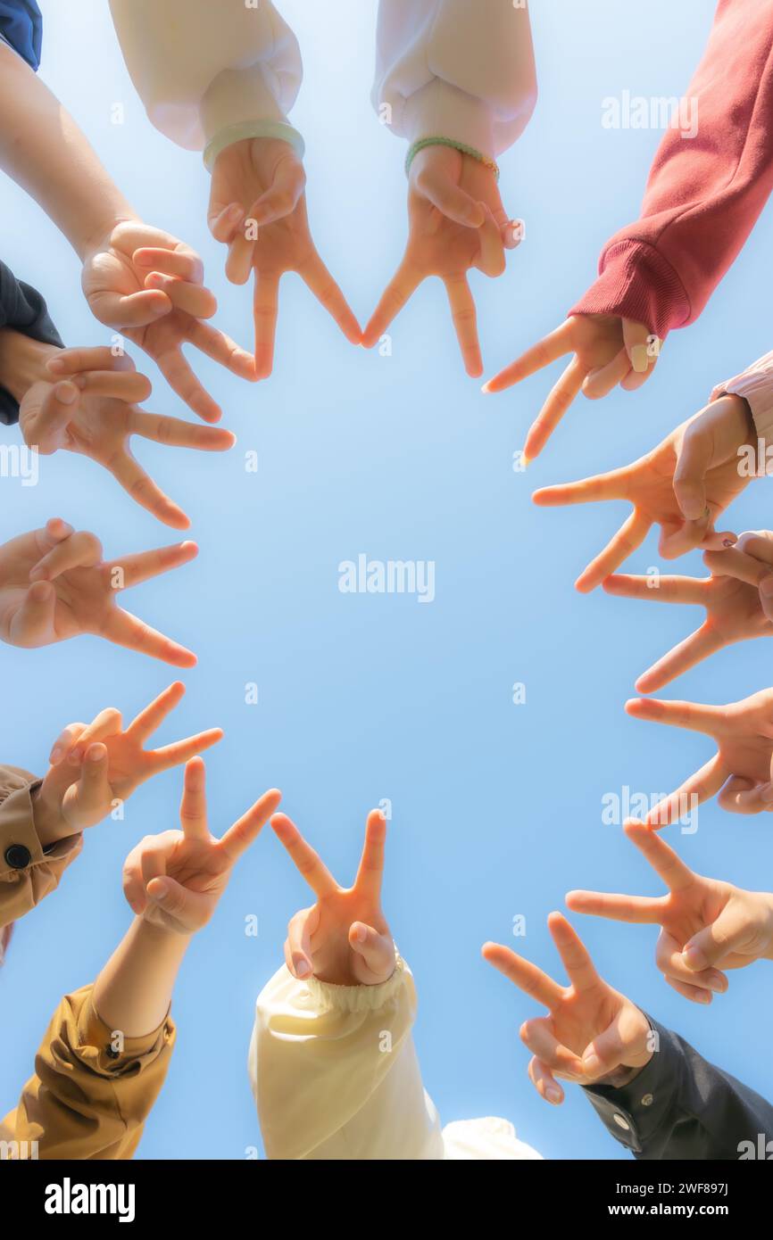 A group of people use their hands to create the shape of Ye Stock Photo ...