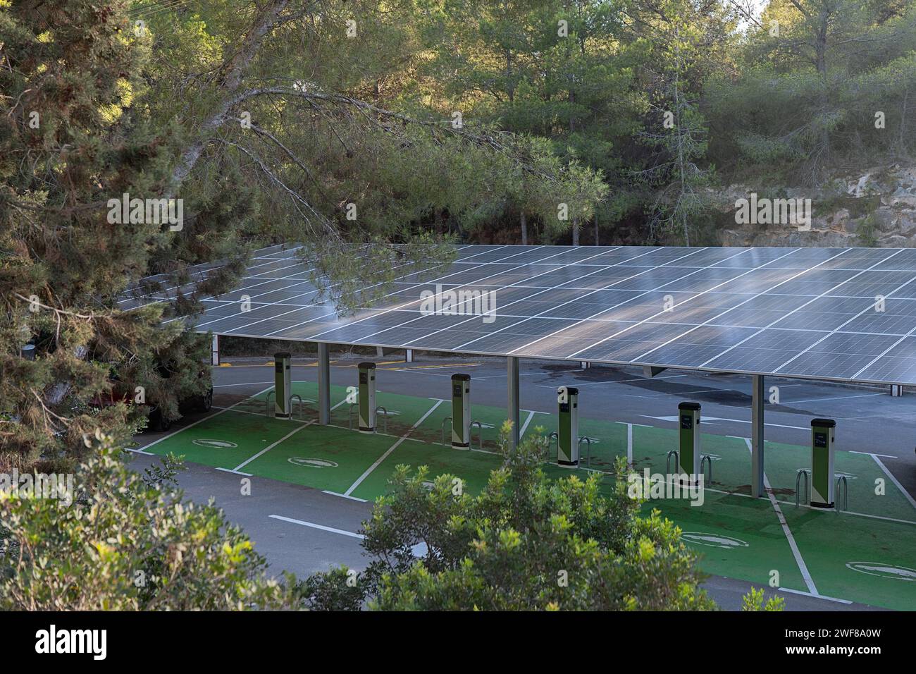A spacious parking lot equipped with multiple solar panel canopies ...