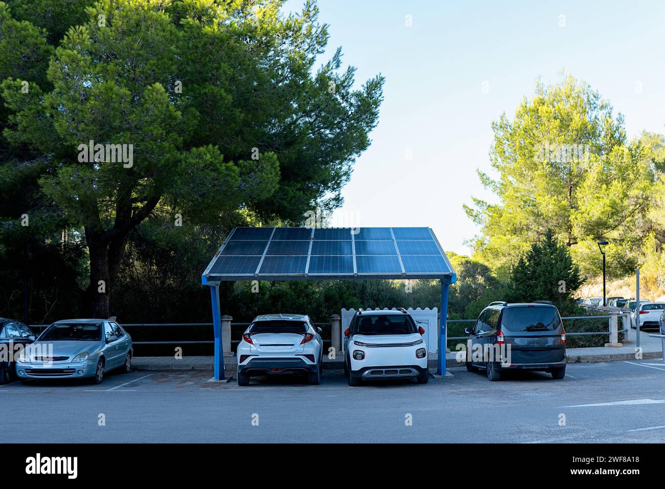 A parking area with a single solar panel structure providing shade and ...