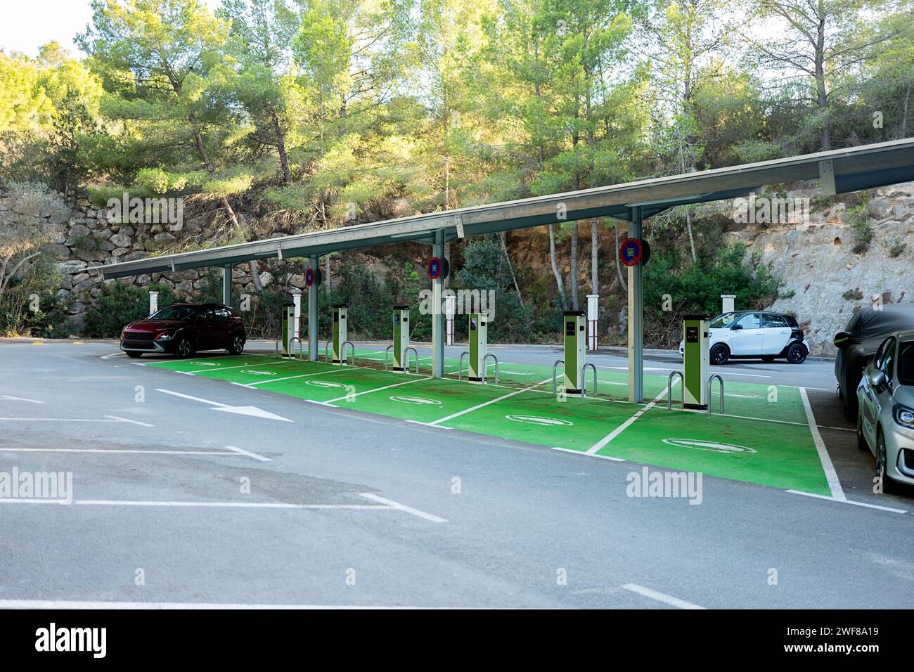 A spacious parking lot equipped with multiple solar panel canopies ...