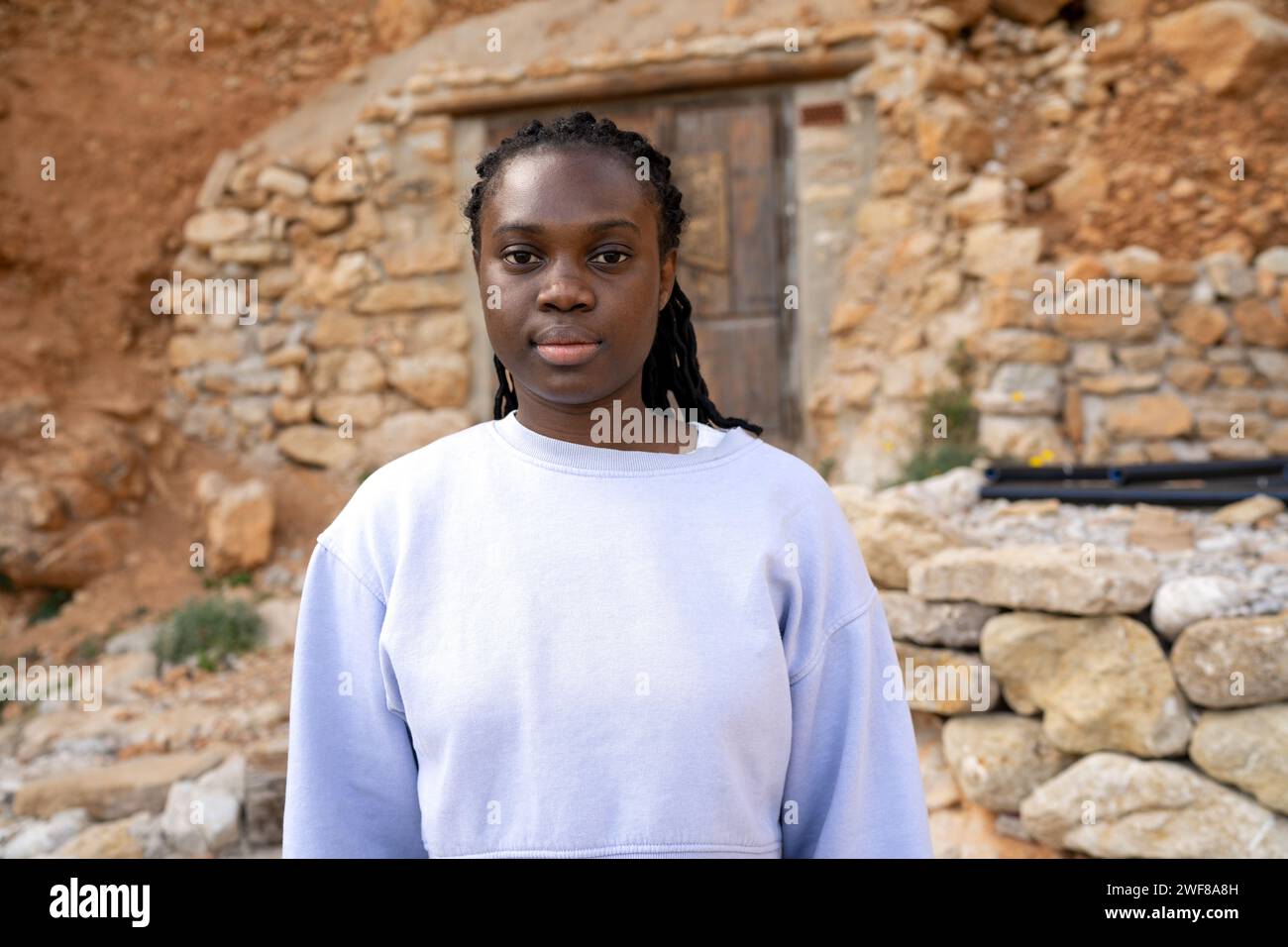 African American confident young woman standing looking at camera in ...