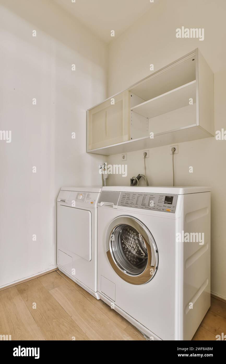 A clean and minimalistic laundry room featuring a modern white washing ...