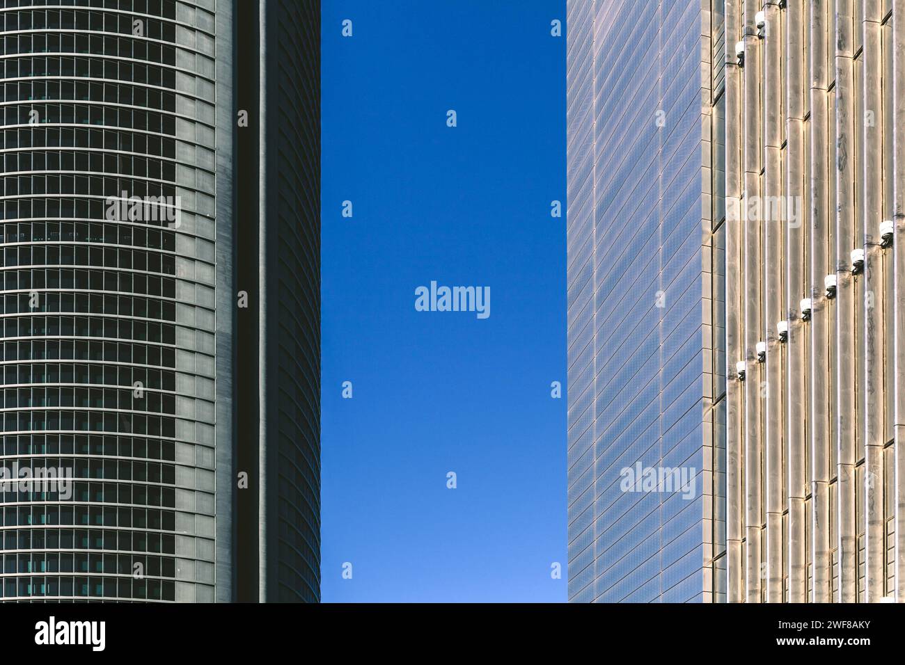 The photo highlights the juxtaposition of two distinct building facades ...