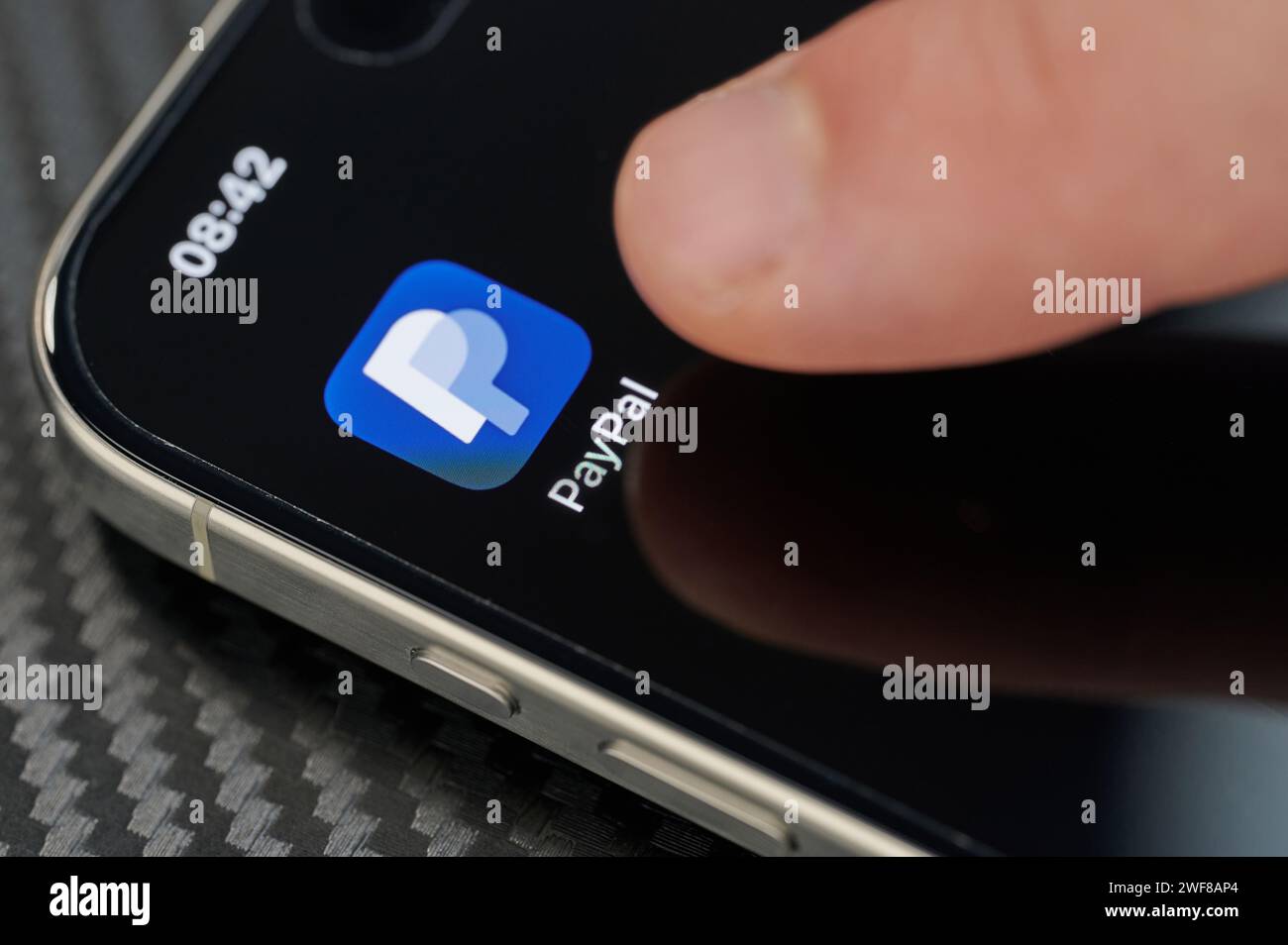 New York, USA - January 24, 2024: Touching top open Paypal app icon ...