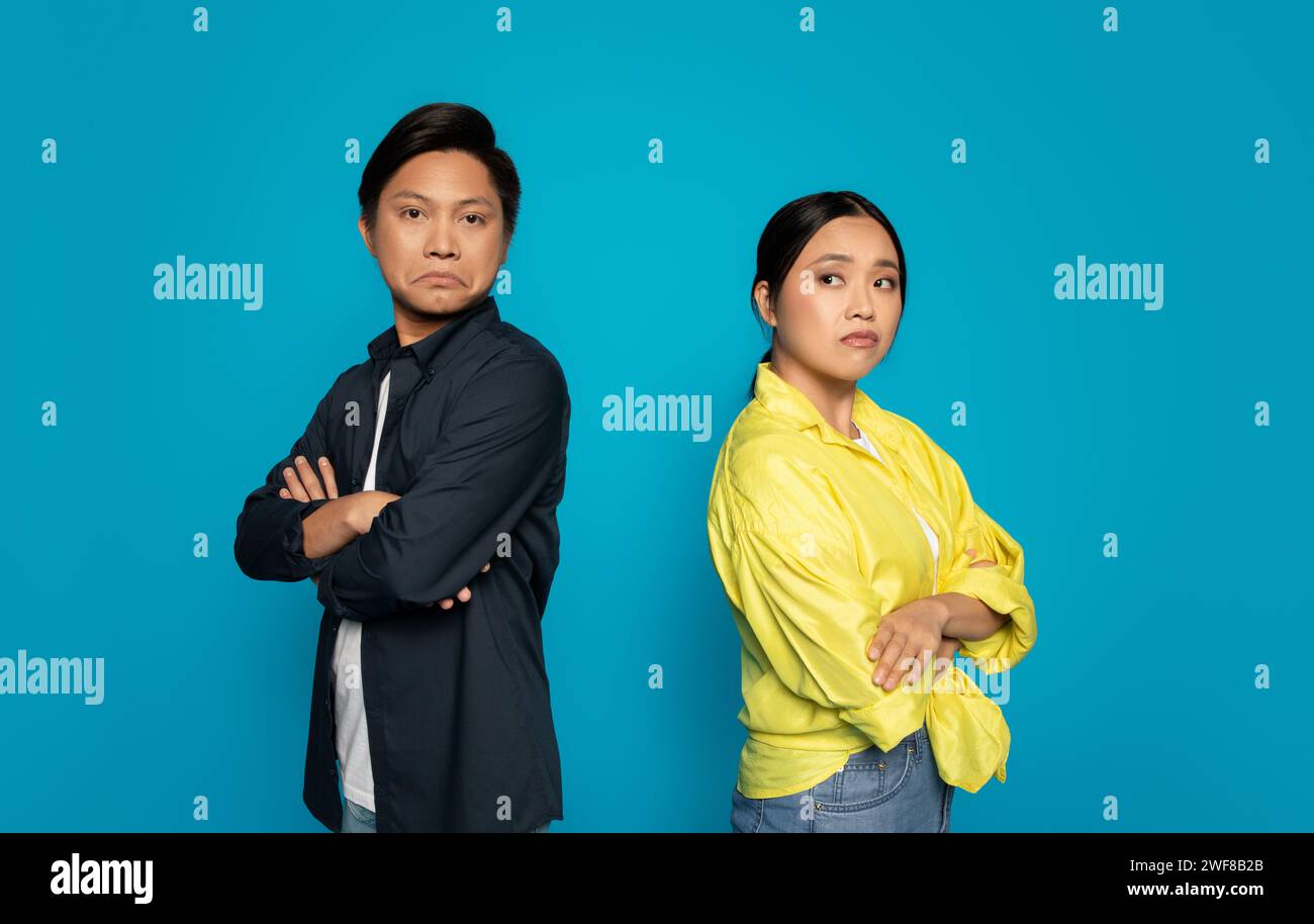 Stern-faced man and woman with arms crossed, showing a defiant or ...