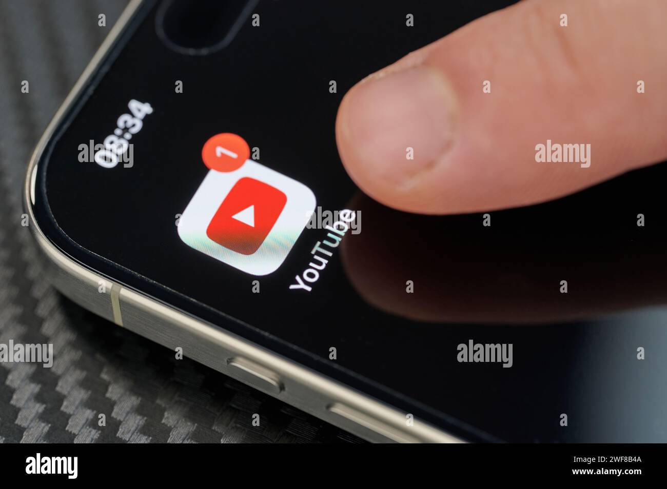 New York, USA - January 24, 2024: Touching top open Youtube app icon ...