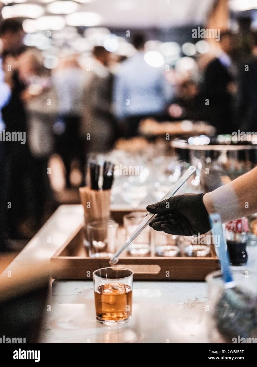 Expert barman is making cocktail at business banquet event in hotel ...