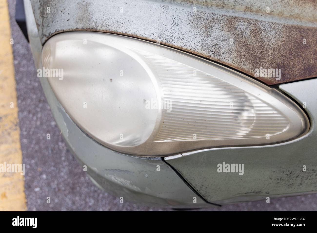 Hazy opaque foggy front head lamp of car reduces light pass-through and ...