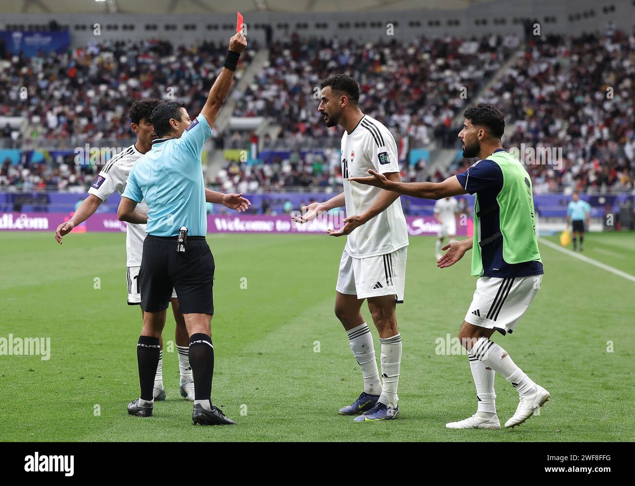 Doha, Qatar. 29th Jan, 2024. Iraq's Aymen Hussein (2nd R) receives a ...