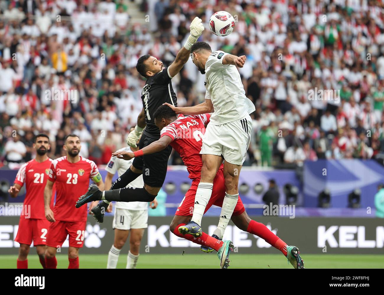 Doha, Qatar. 29th Jan, 2024. Jordan's goalkeeper Yazeed Abulaila (top L) makes a save during the ...